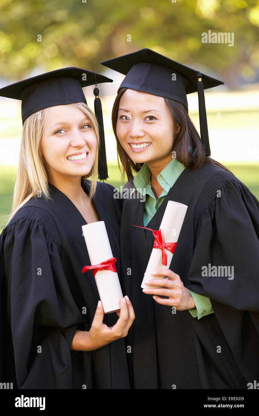 Two Female Students Attending Graduation Ceremony Stock Photo - Alamy