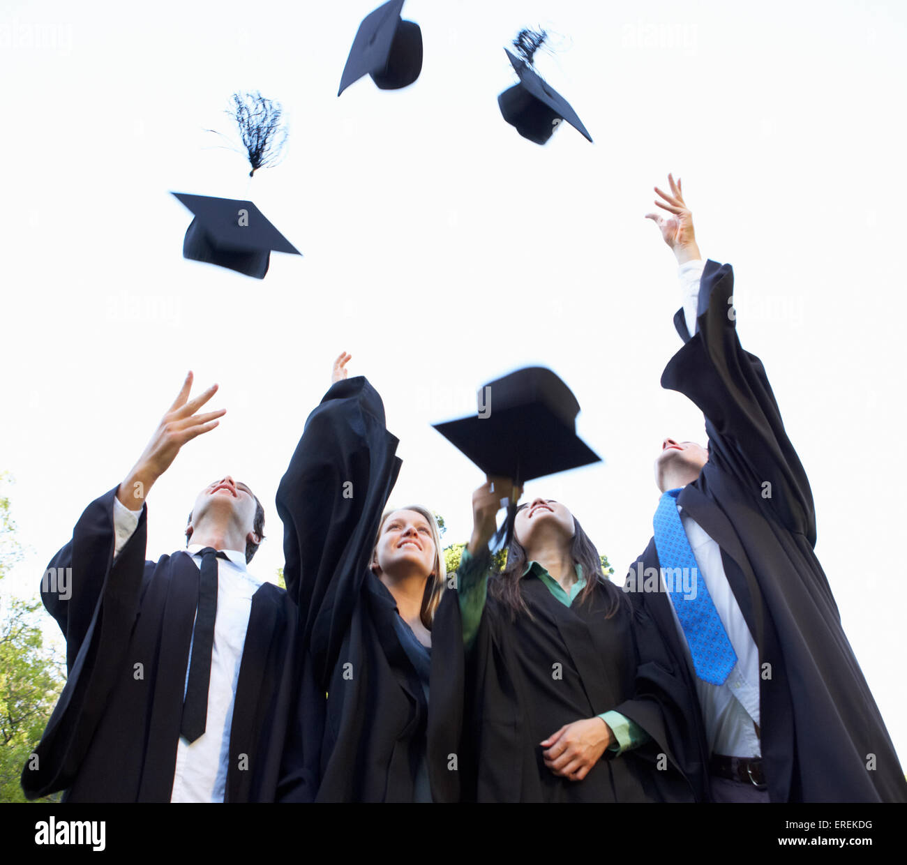 Group Of Students Attending Graduation Ceremony throwing Mortar Boards ...