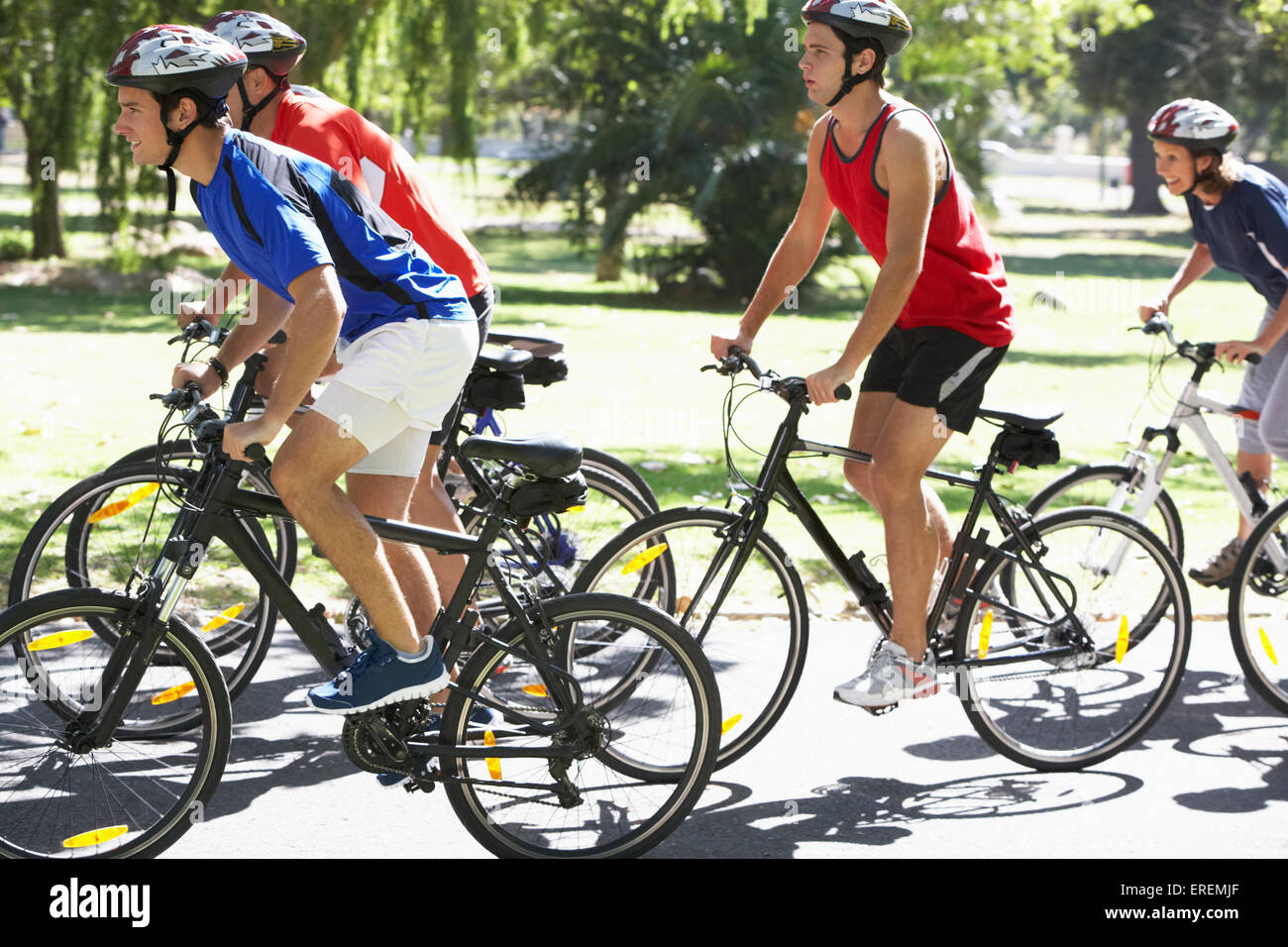 Group Of Cyclists On Cycle Ride Through Park Stock Photo - Alamy