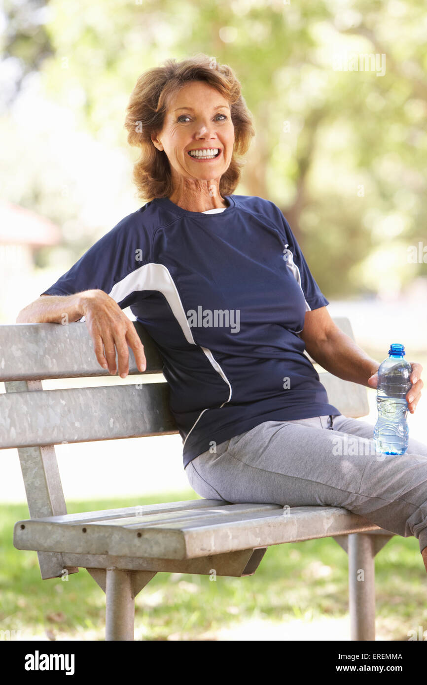 Senior Woman Resting After Exercise In Park Stock Photo - Alamy