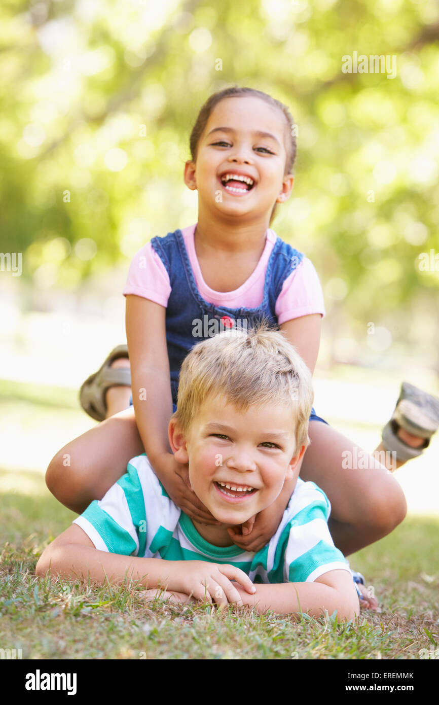 Two Children Playing Together In Park Stock Photo - Alamy