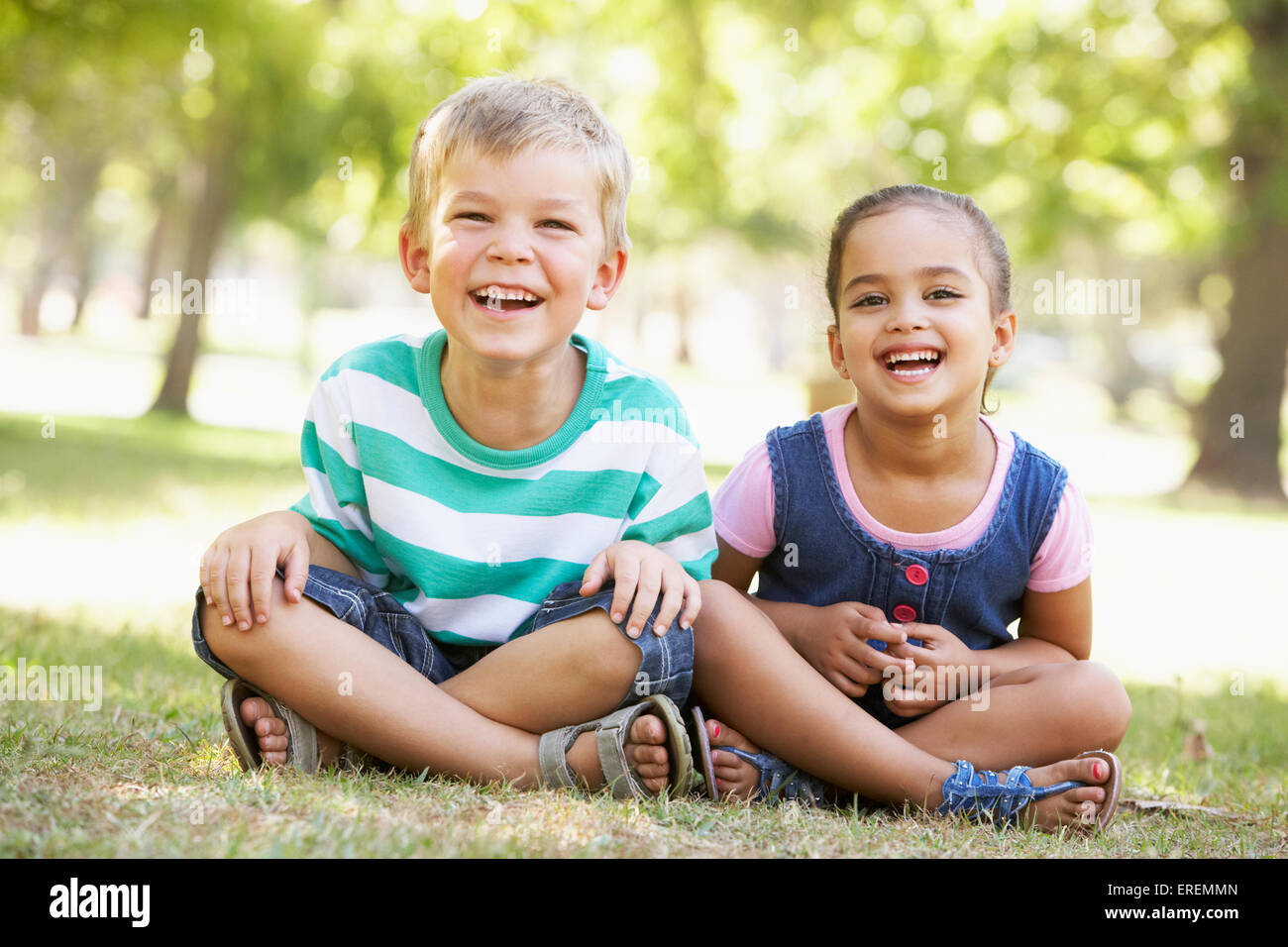 Two Children Playing Together In Park Stock Photo - Alamy