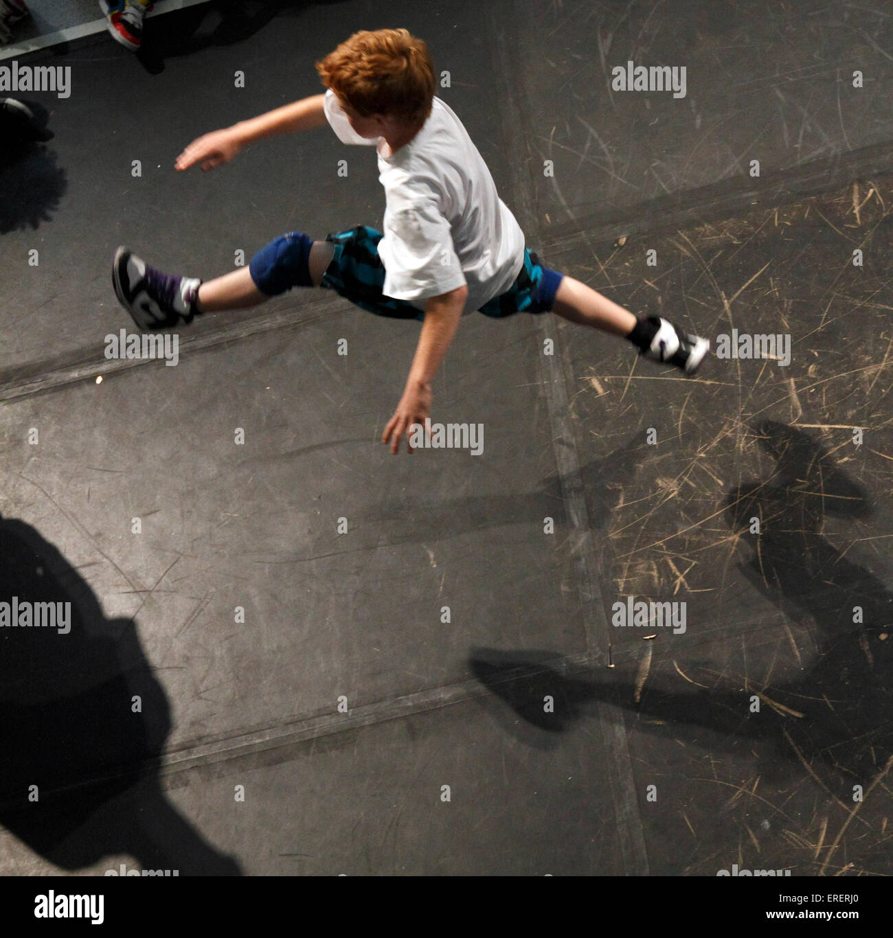 Boy taking part in a streetdance demonstration, jumping Stock Photo - Alamy