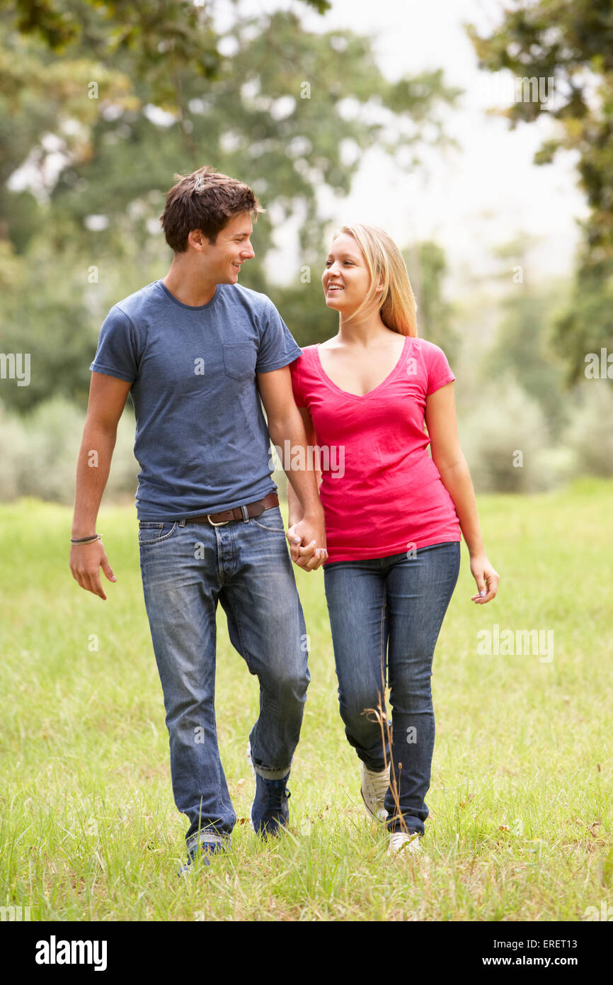 Romantic Young Couple Walking Through Countryside Stock Photo - Alamy