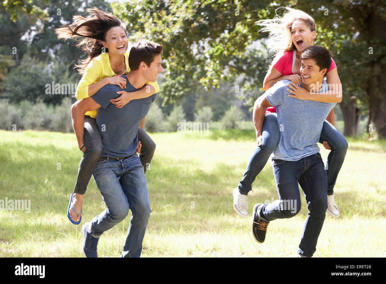 Group Of Young Friends Running Through Countryside Stock Photo - Alamy