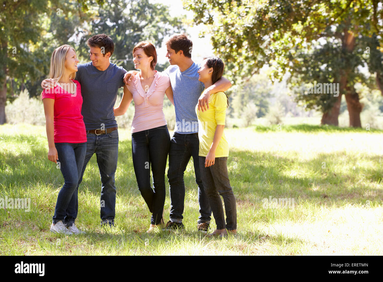 Group Of Young Friends Walking Through Countryside Stock Photo - Alamy