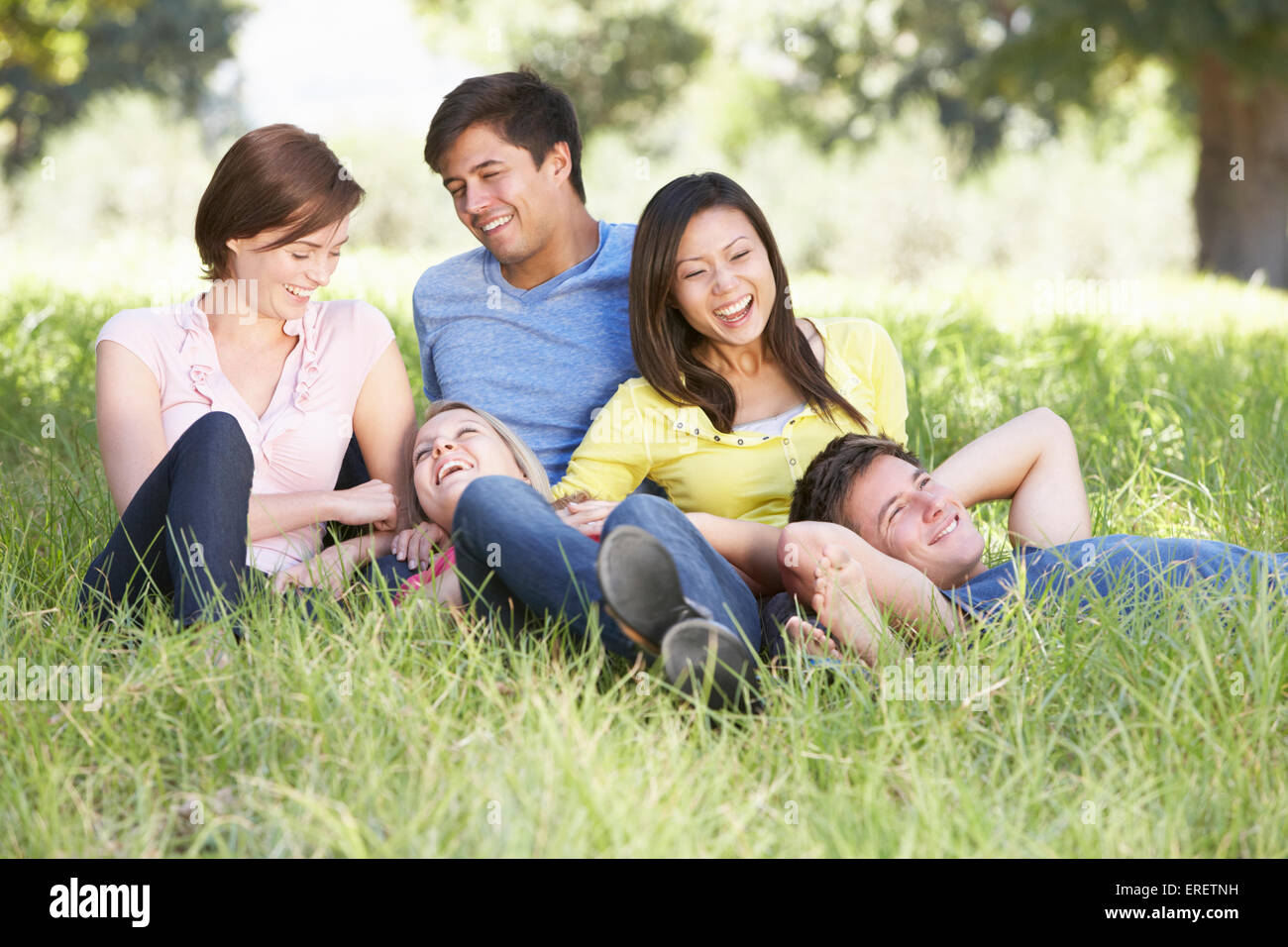 Group Of Young Friends Relaxing In Countryside Stock Photo - Alamy