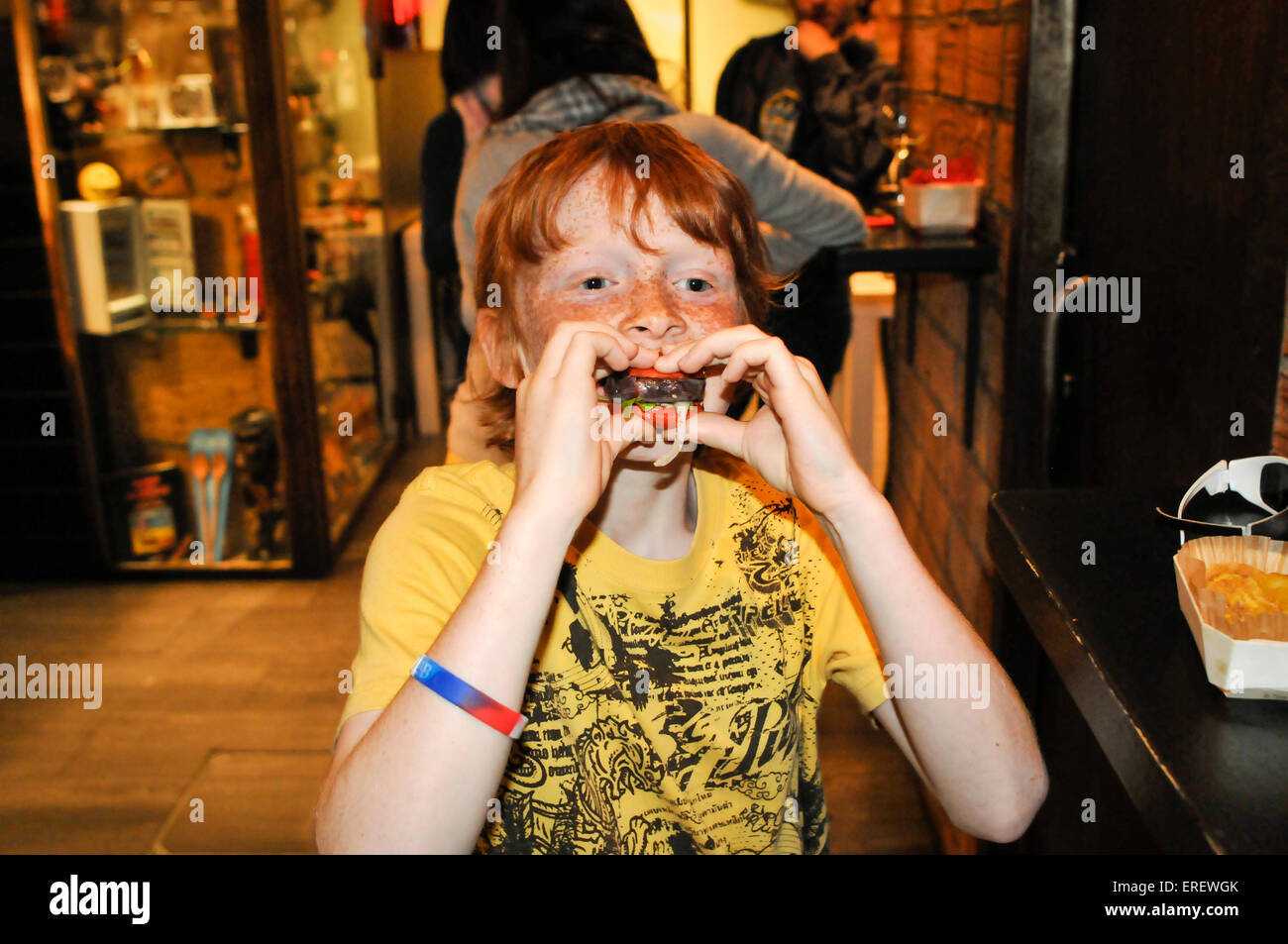 Young boy helps himself to Pintox tapas in a bar in San Sebastion ...