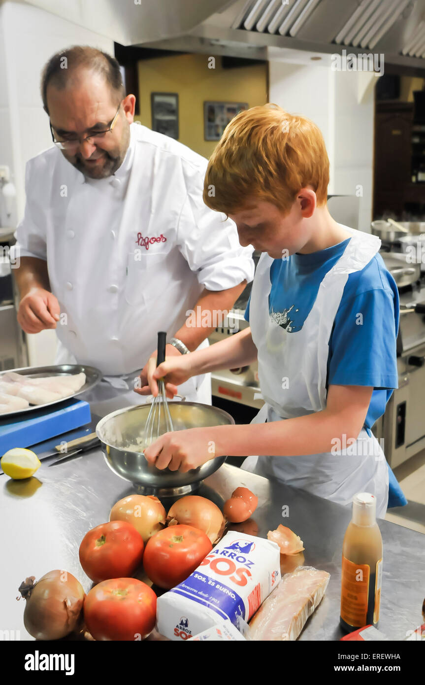 Boys having a cooking lesson in a traditional members only Basque ...