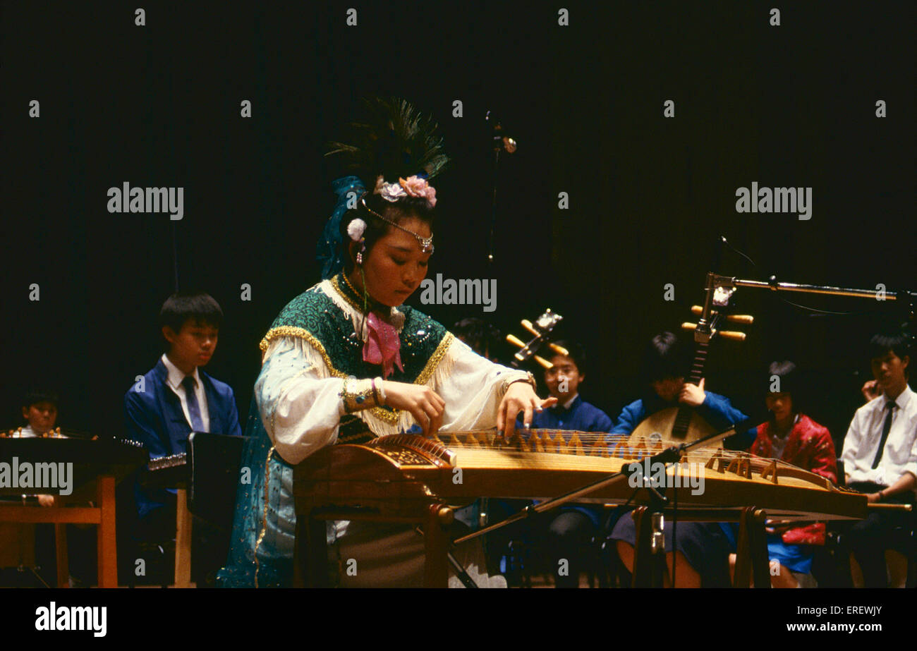 Female Chinese musician playing a guzheng, one of the oldest plucked ...