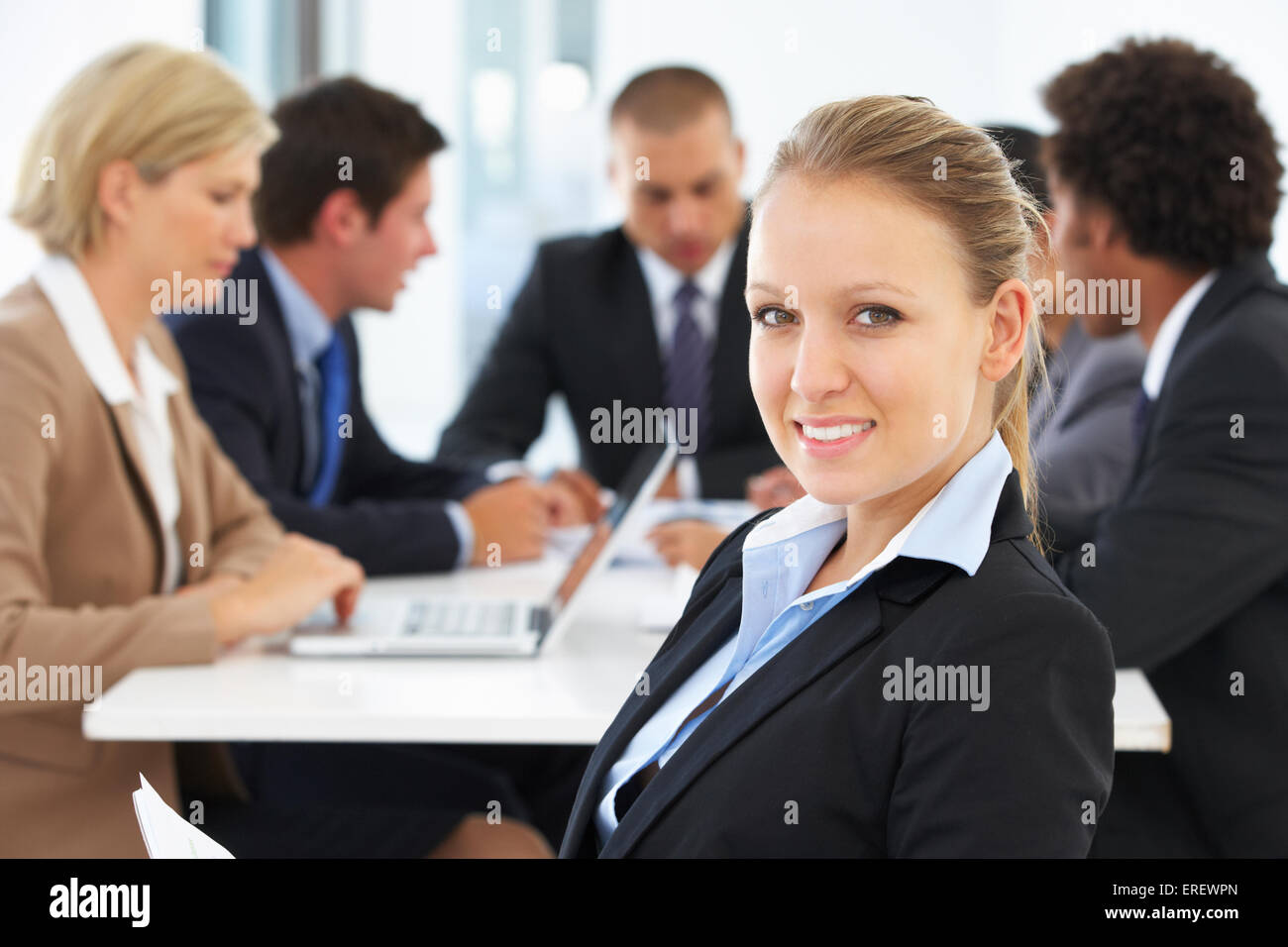 Portrait Of Female Executive With Office Meeting In Background Stock ...