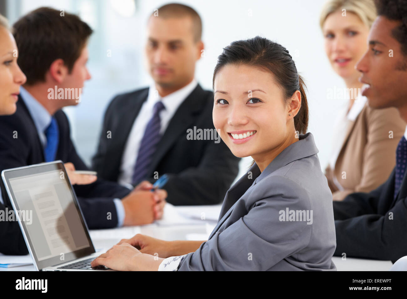 Portrait Of Female Executive With Office Meeting In Background Stock ...