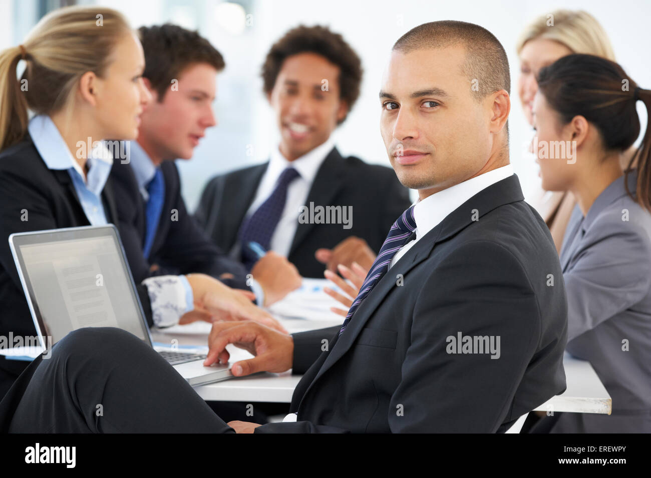 Portrait Of Male Executive With Office Meeting In Background Stock ...