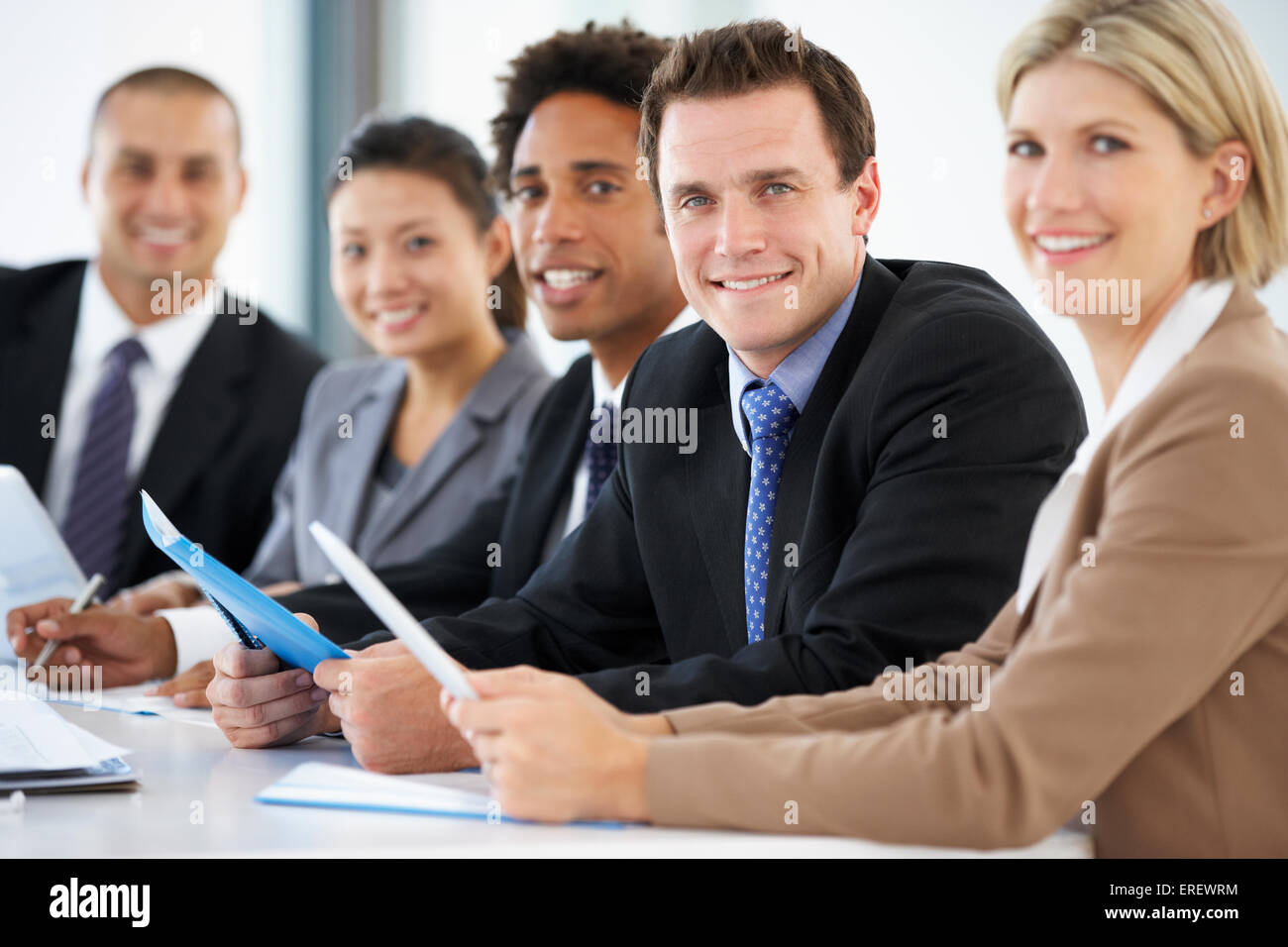 Portrait Of Male Executive Attending Office Meeting With Colleagues ...