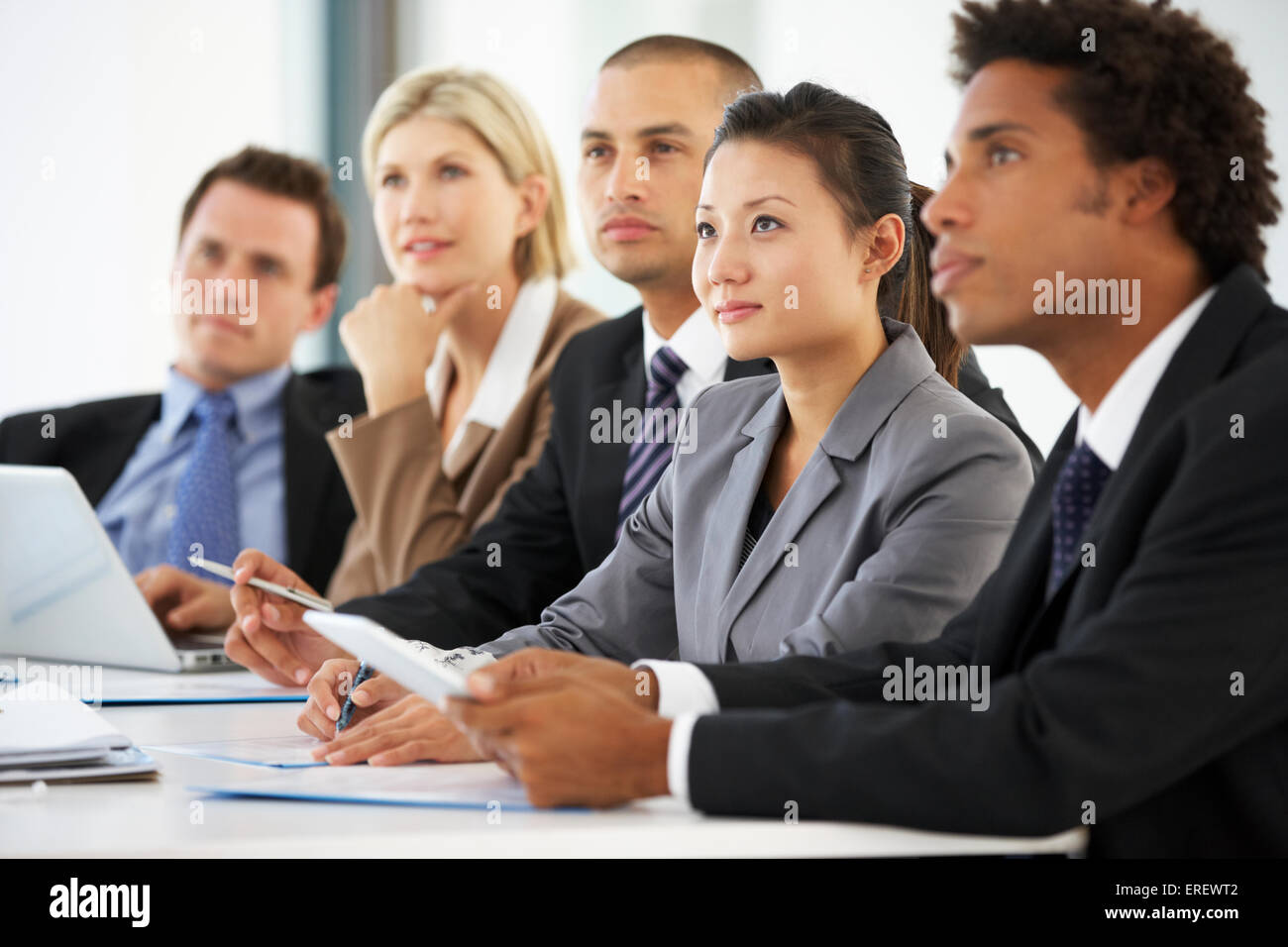 Businesswoman addressing colleagues table hi-res stock photography and ...