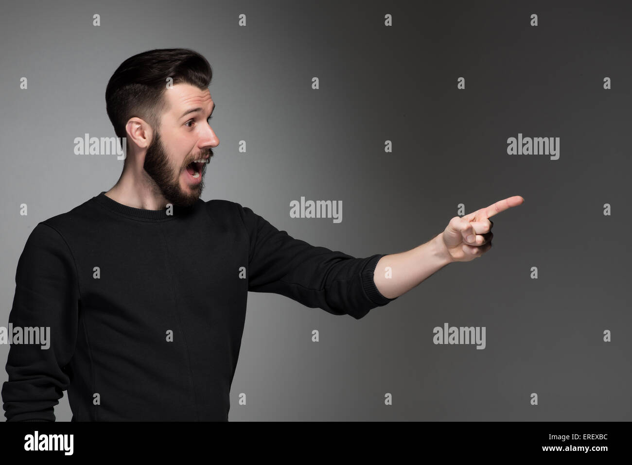 Excited man pointing a great idea over a gray background Stock Photo ...