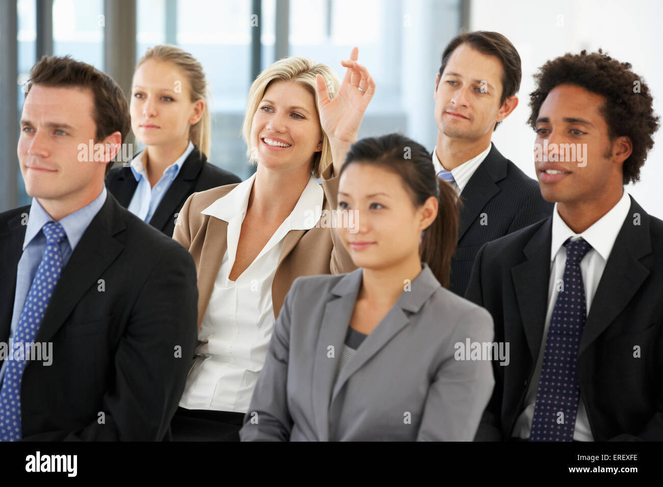 Businesswoman Asking Question During Presentation Stock Photo - Alamy