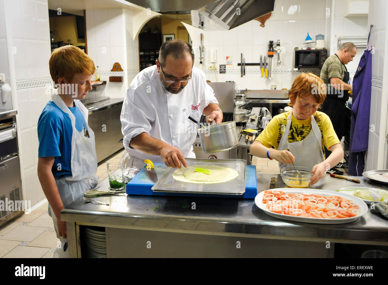Boys having a cooking lesson in a traditional members only Basque ...