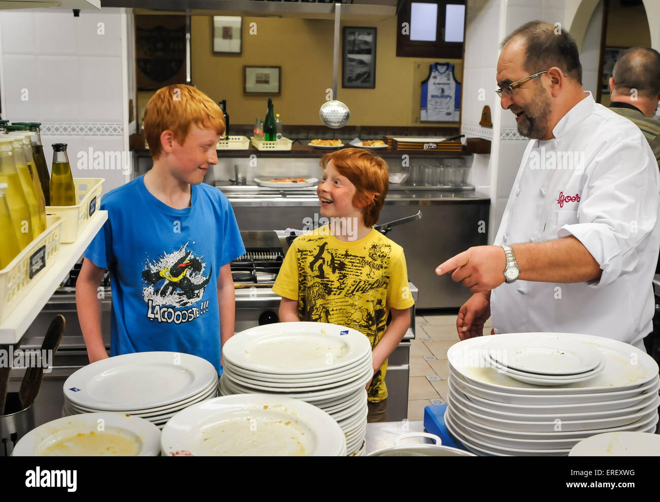 Boys having a cooking lesson in a traditional members only Basque ...
