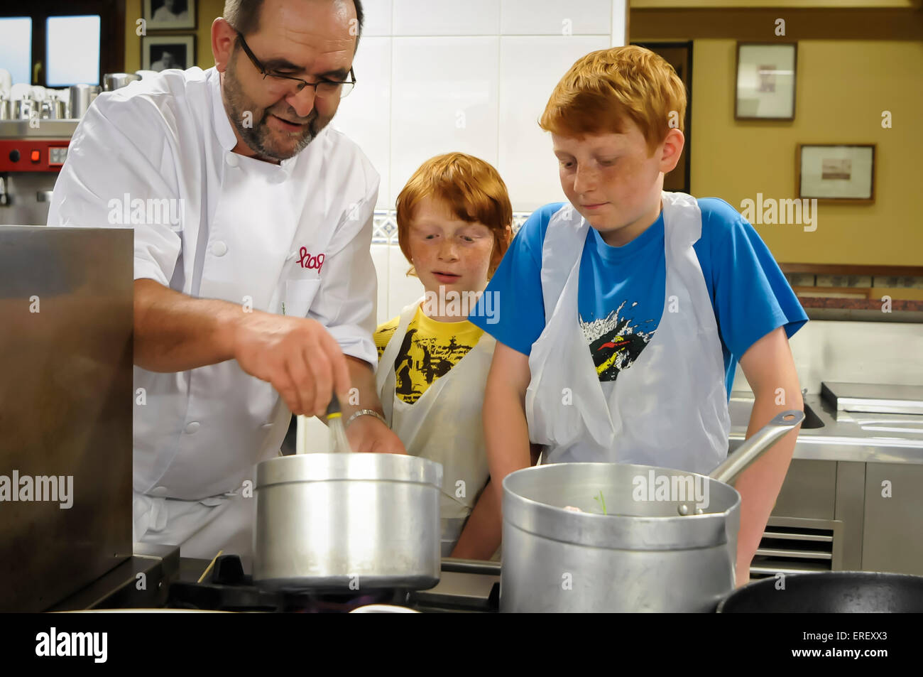 Boys having a cooking lesson in a traditional members only Basque ...