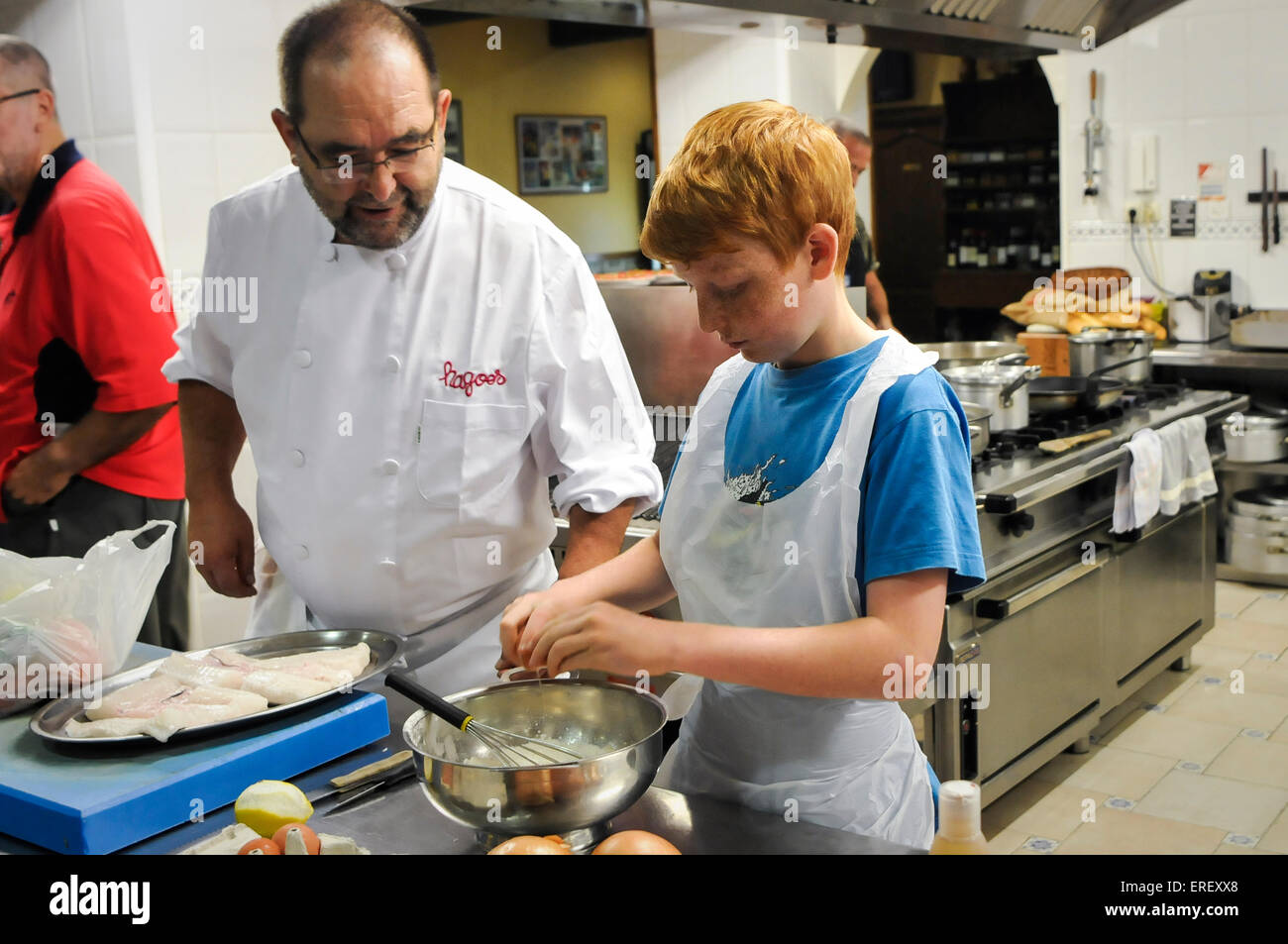 Boys having a cooking lesson in a traditional members only Basque ...