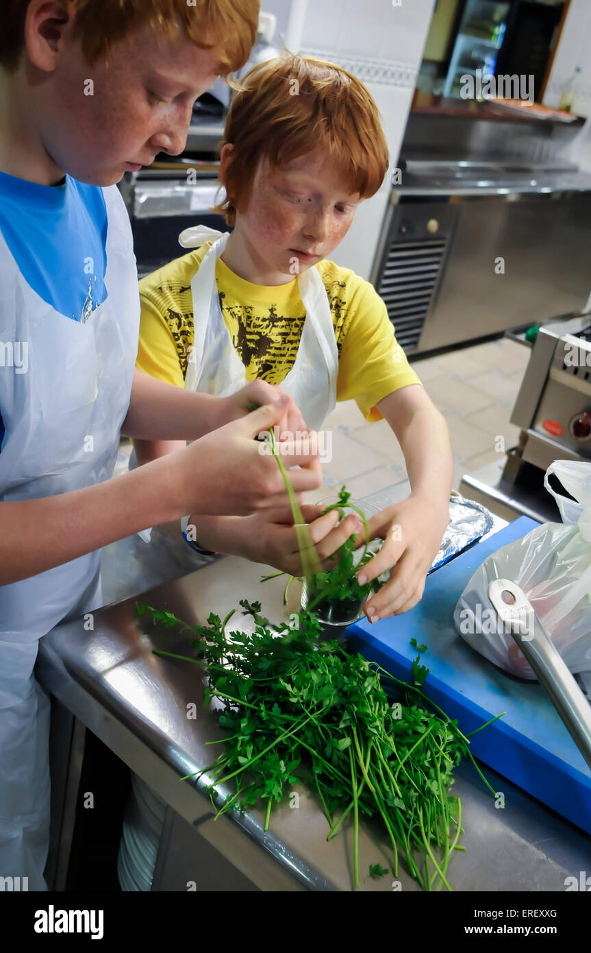 Boys having a cooking lesson in a traditional members only Basque ...