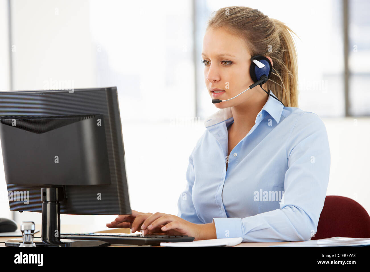 Friendly Service Agent Talking To Customer In Call Centre Stock Photo ...