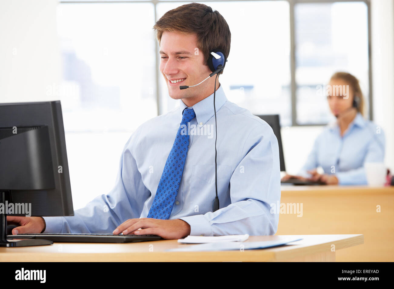 Friendly Service Agent Talking To Customer In Call Centre Stock Photo ...