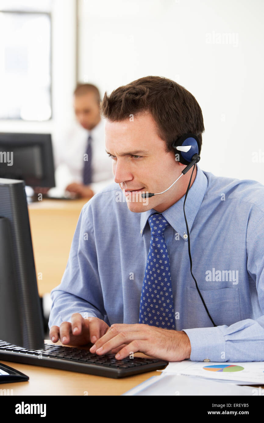 Friendly Service Agent Talking To Customer In Call Centre Stock Photo ...