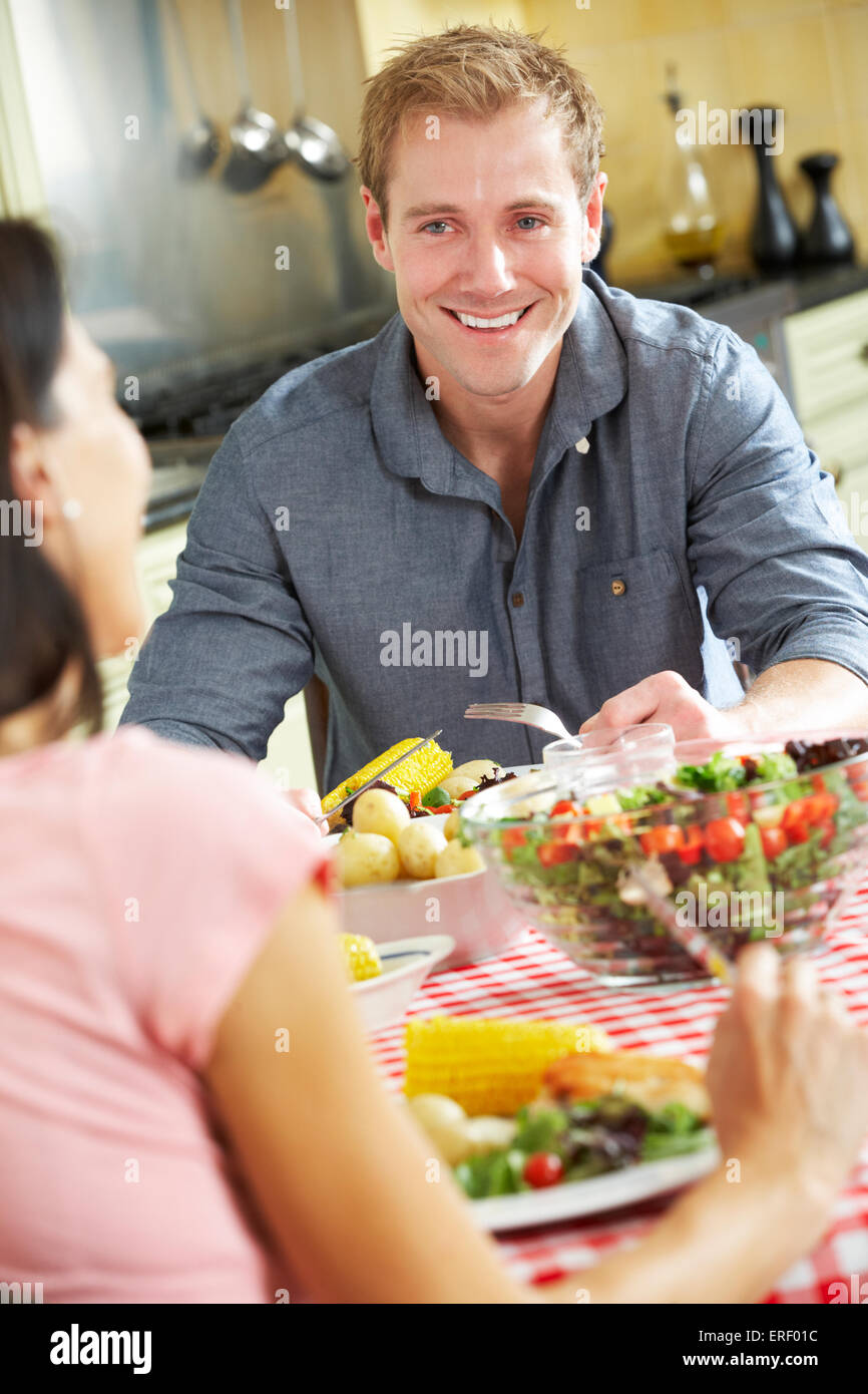 Couple Eating Meal Together In Kitchen Stock Photo - Alamy