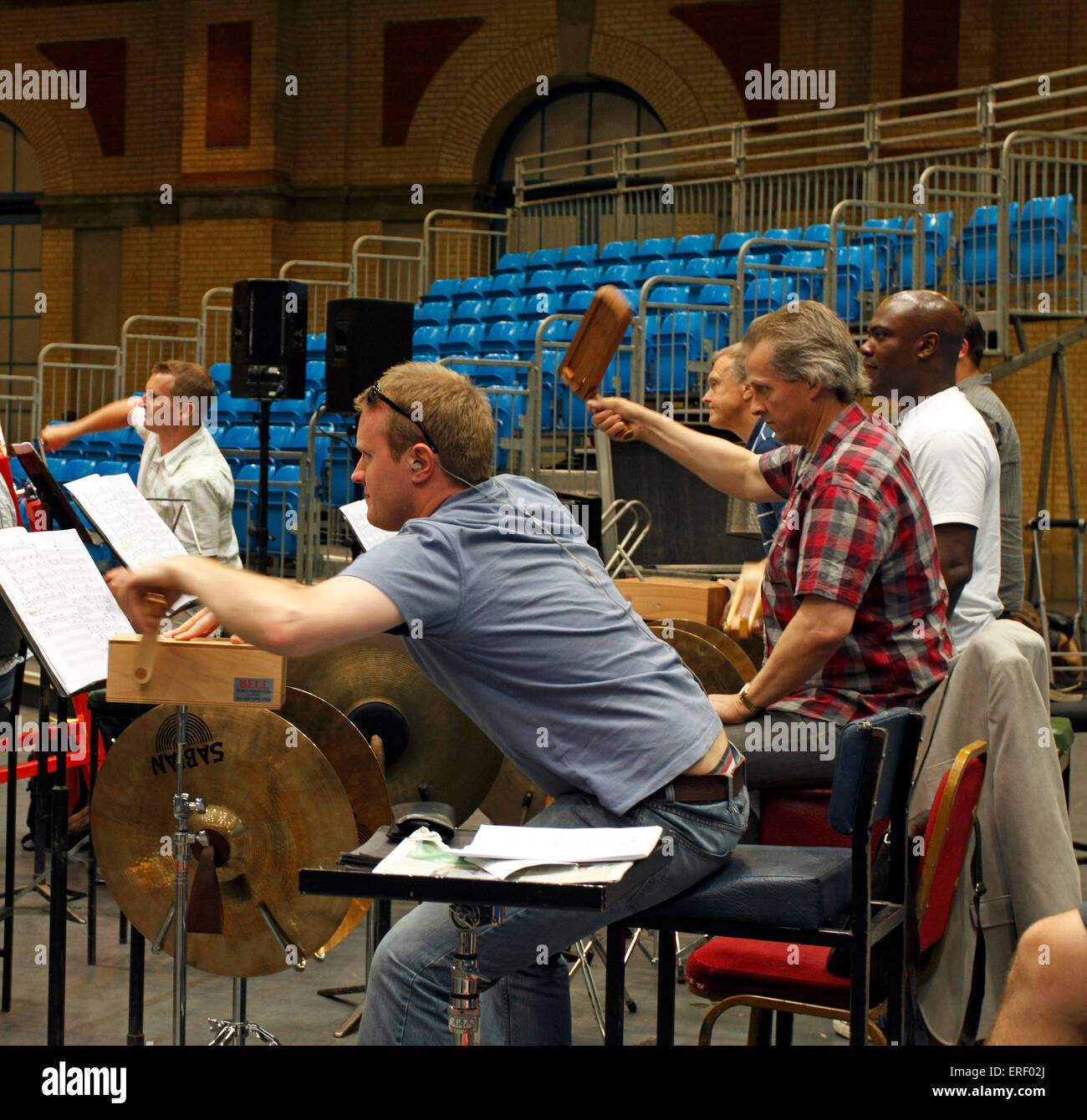 Percussion section playing assorted rattles or ratchets Stock Photo - Alamy