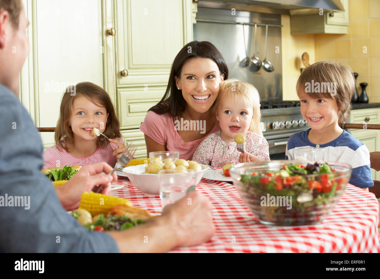 Family Eating Meal Together In Kitchen Stock Photo - Alamy