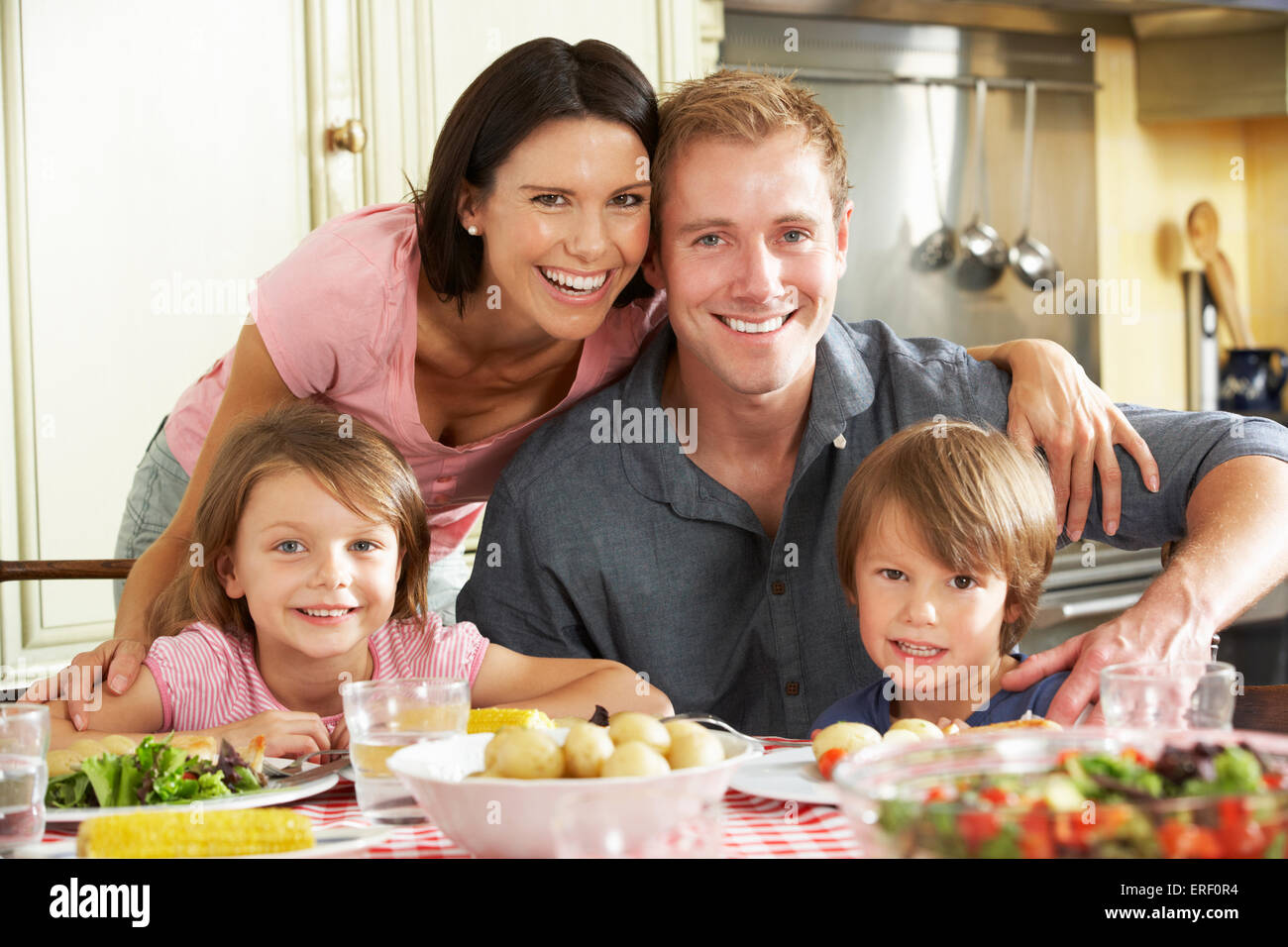 Family Eating Meal Together In Kitchen Stock Photo - Alamy