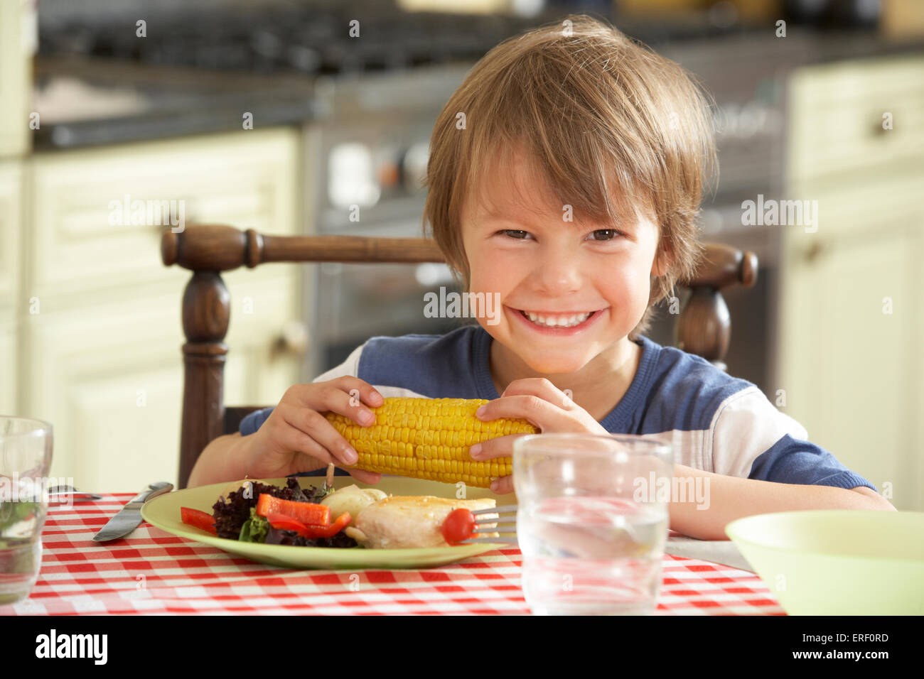 Young Boy Eating Meal In Kitchen Stock Photo - Alamy