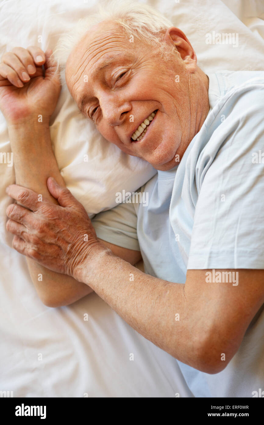 Senior Man Relaxing In Bed Stock Photo - Alamy