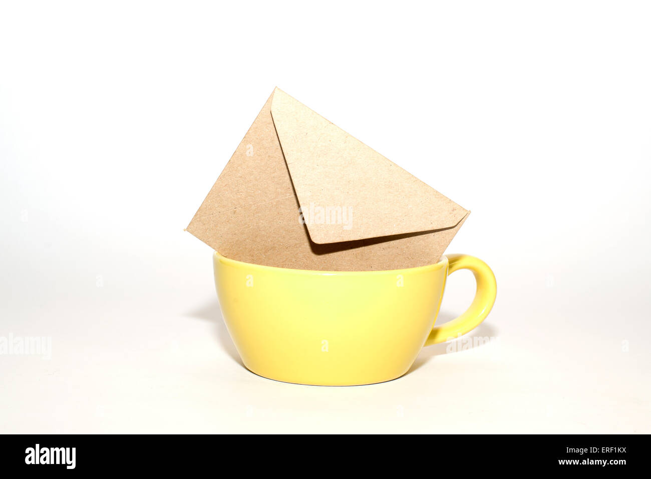 Mailing Envelope in the yellow cup on a white background Stock Photo ...