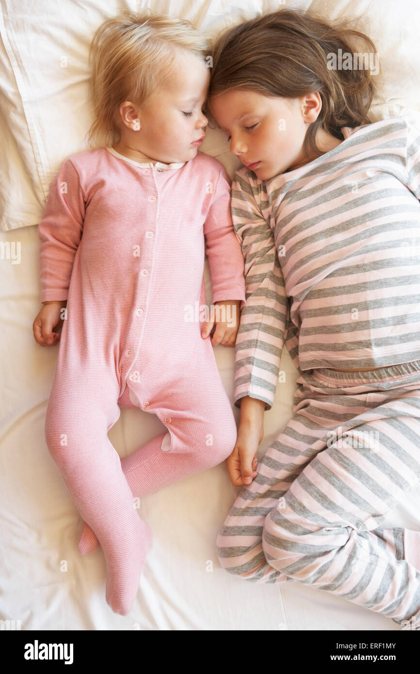 Two Young Girls Sleeping In Bed Stock Photo - Alamy