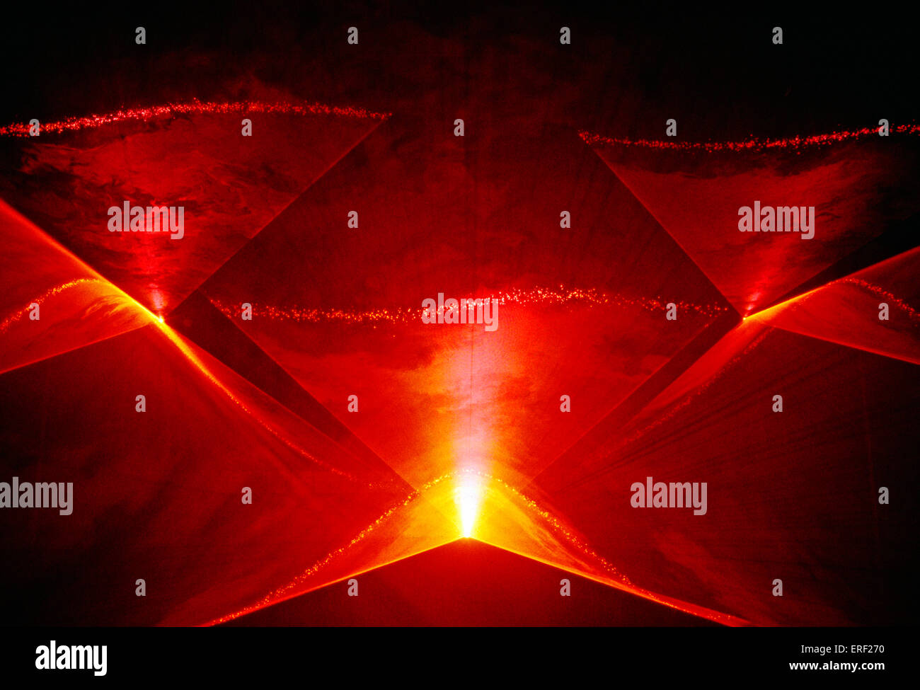 Undulating, red flattened laser beams enhanced by smoke and reflecting ...