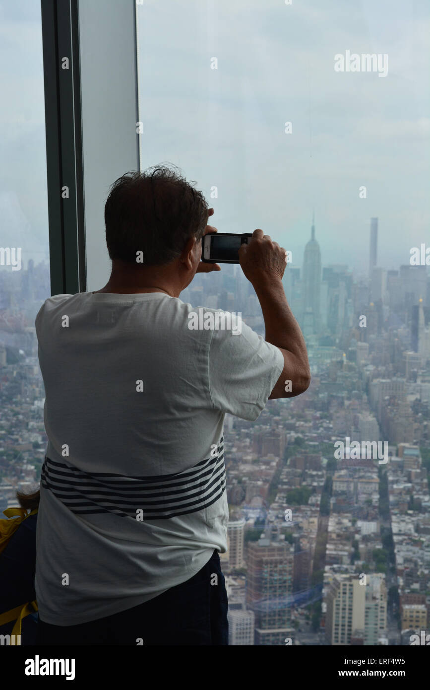 Man taking photos from the Observation Deck at World Trade Center Tower ...