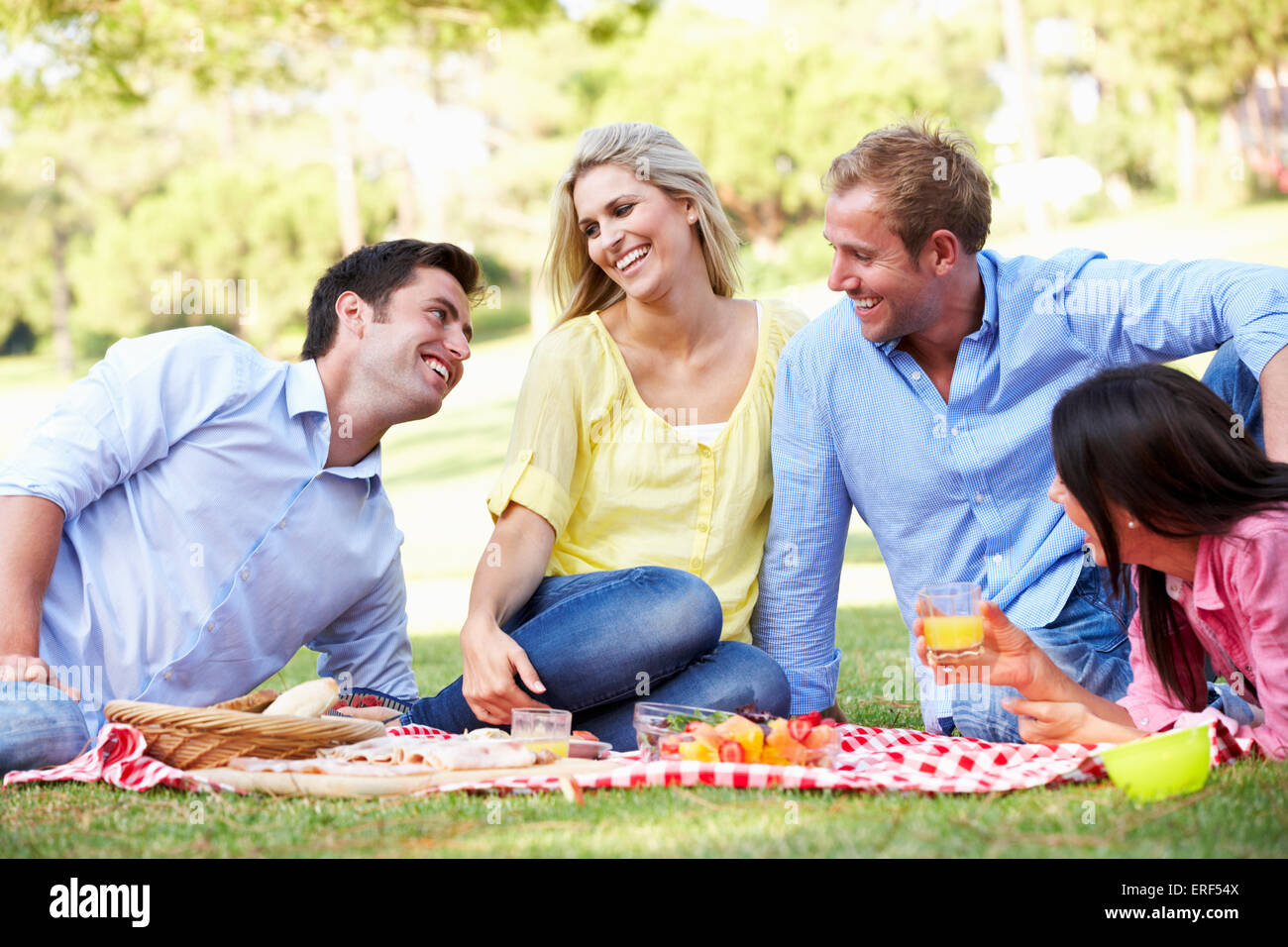 Group Of Friends Enjoying Picnic Together Stock Photo - Alamy