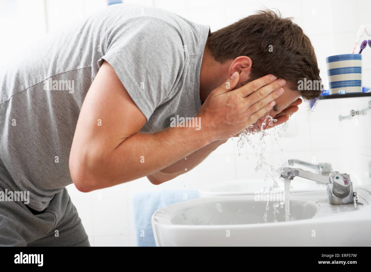 Man Washing Face In Bathroom Sink Stock Photo - Alamy