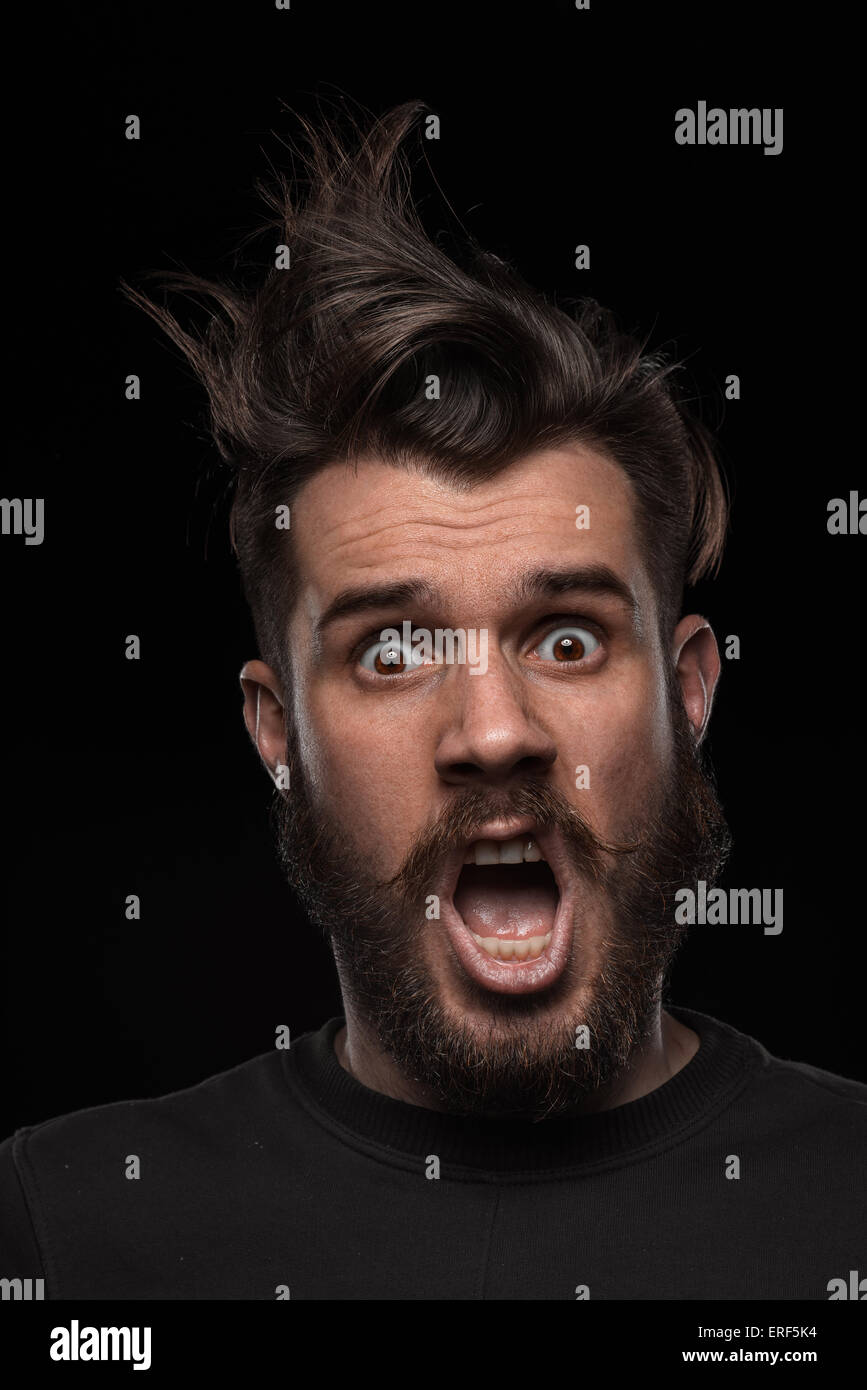 Portrait of young frightened crying man with a beard and mustache in ...