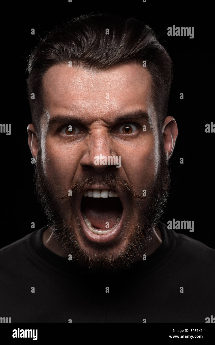 Portrait of young frightened crying man with a beard and mustache in ...