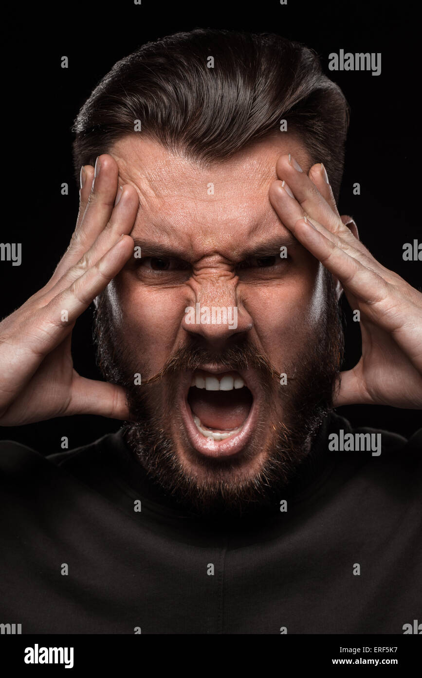 Portrait of young frightened crying man with a beard and mustache in ...