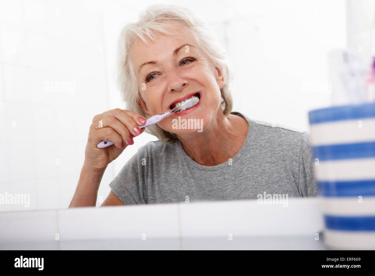 Senior woman brushing teeth in hi-res stock photography and images - Alamy