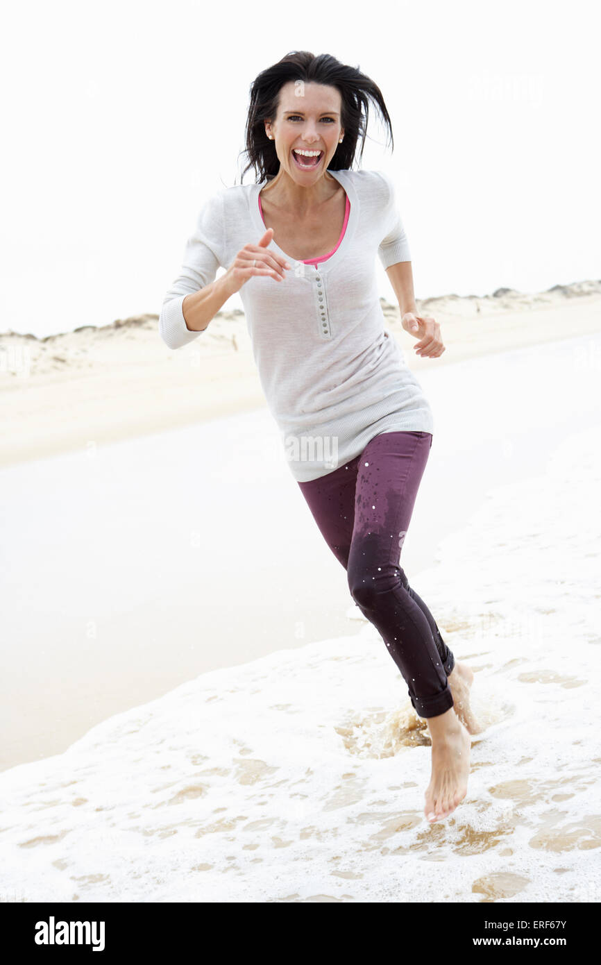 Woman Running Along Beach Stock Photo - Alamy