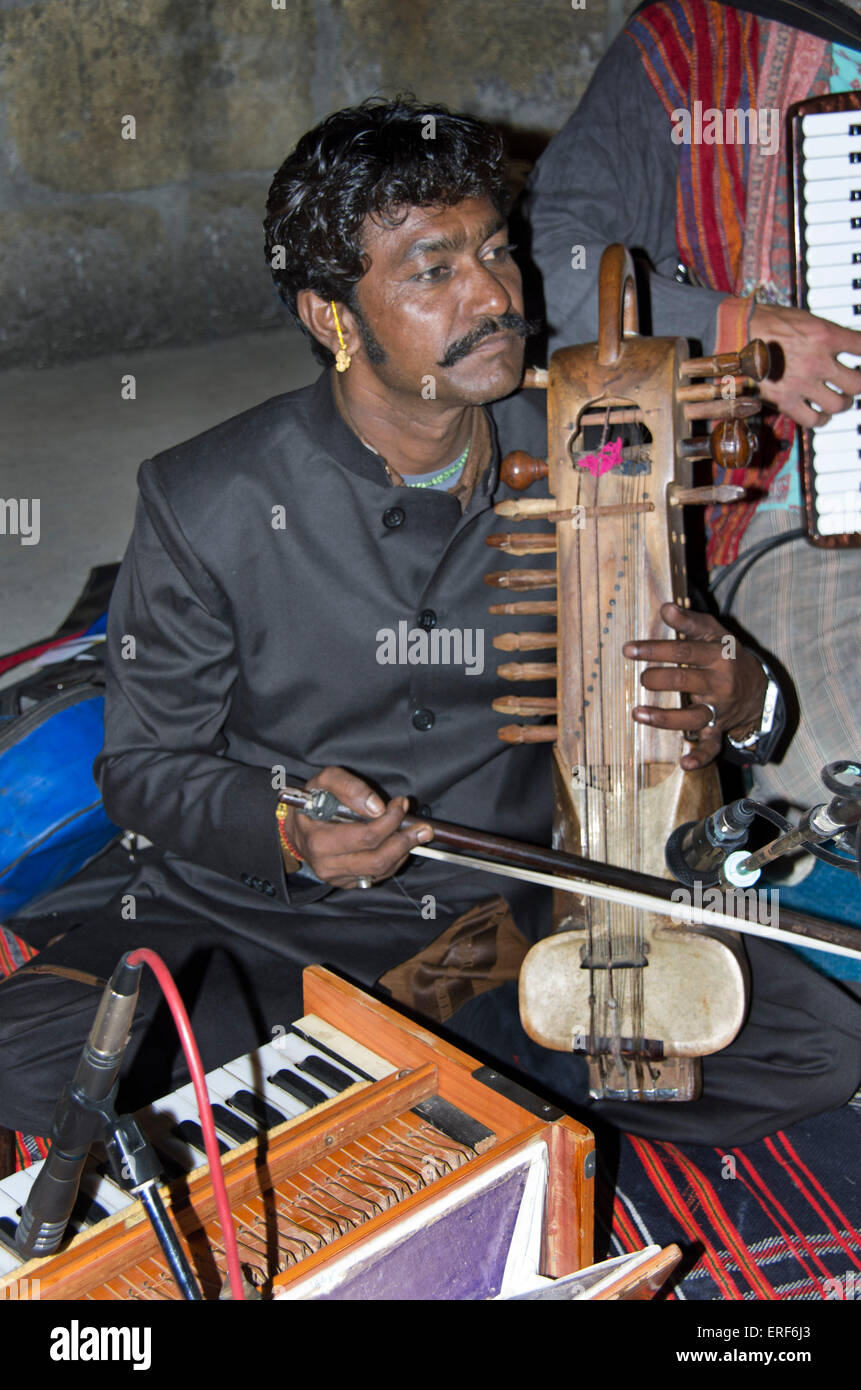 Rajasthani musician Barkat Khan playing a sarangi. The sarangi is the ...