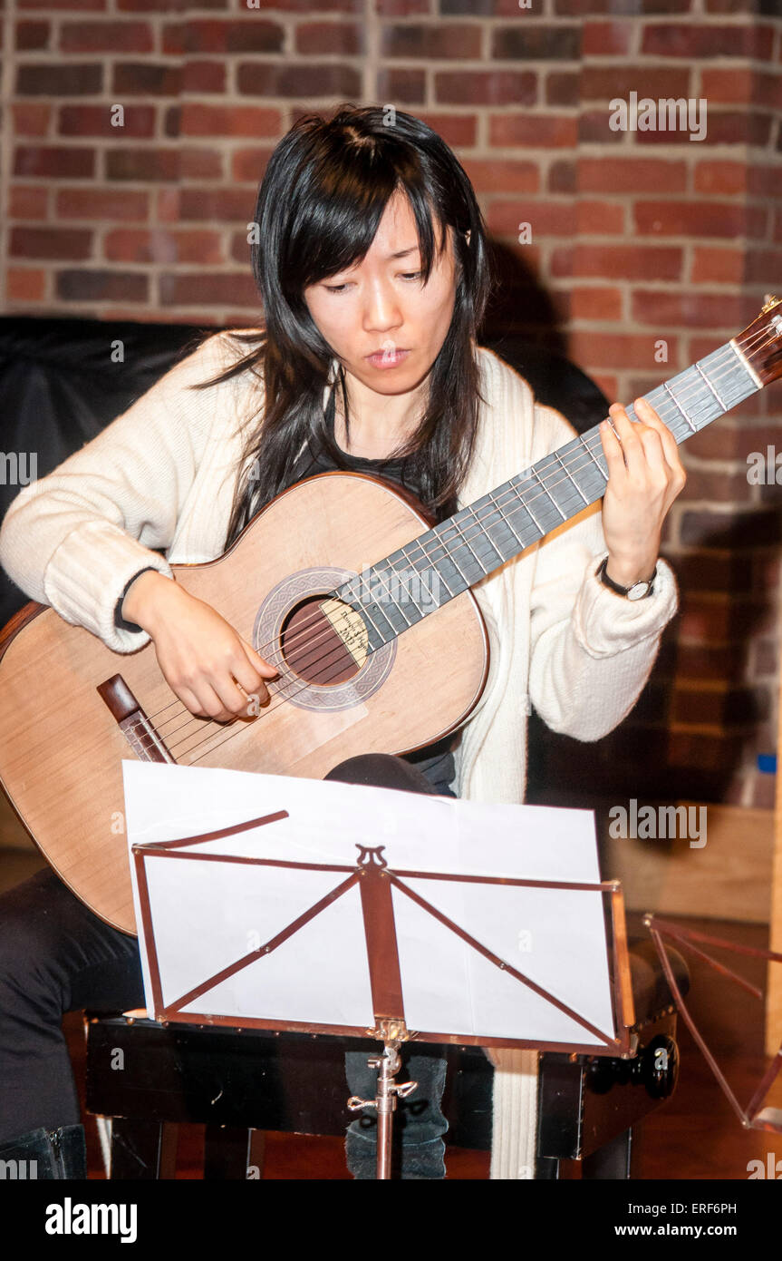 Xuefei Yang playing guitar during rehearsals at the Turner Sims Concert ...