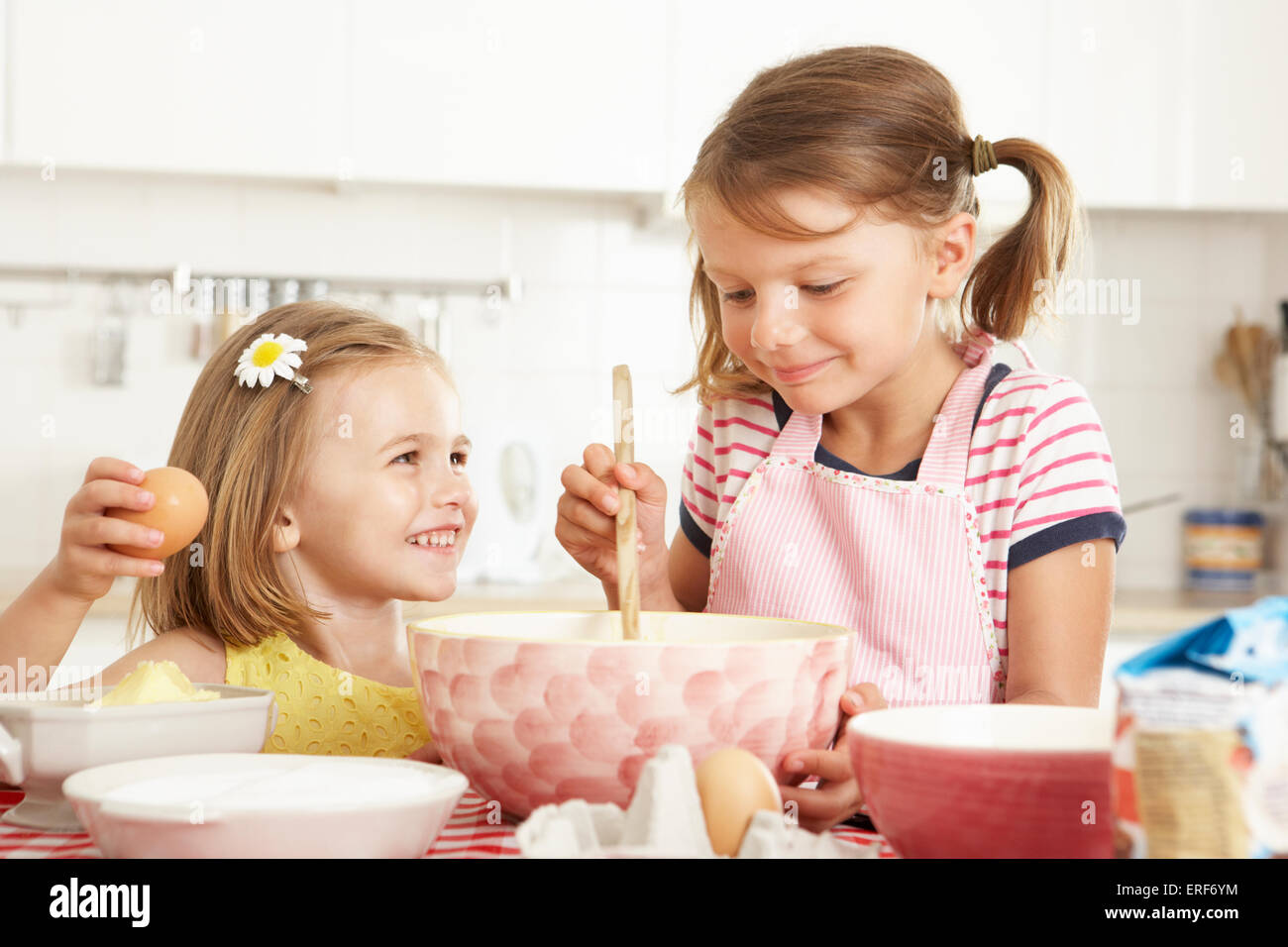 Two Girls Baking In Kitchen Stock Photo - Alamy