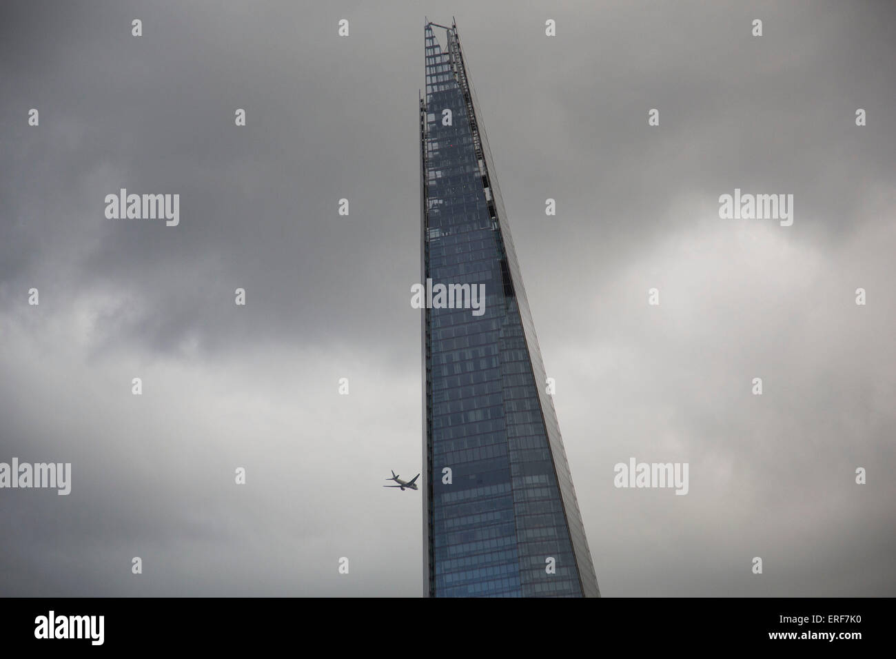 Plane appearing to fly into the Shard in London, UK. The Shard, also ...